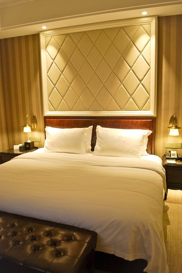 Bed in a hotel room stock image. Image of comfort, hotel - 131901201