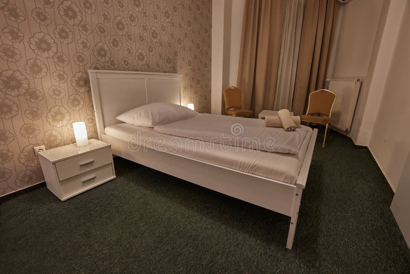 Hotel bed in the evening stock image. Image of place - 236379587