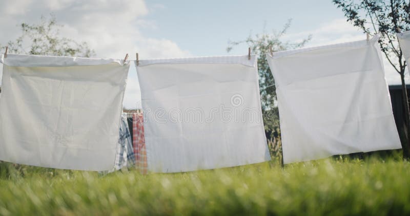 Bed Linens are Drying in the Backyard of the House Stock Photo - Image ...