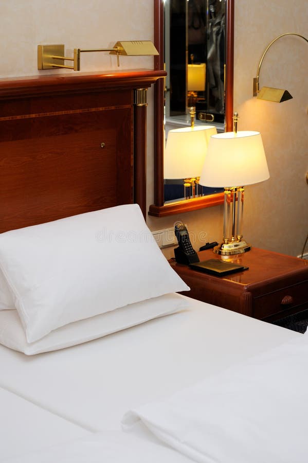 Bed and Night Table in a Hotel Room Stock Photo - Image of phone, hotel ...