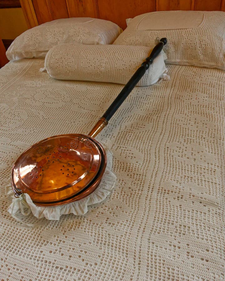 A Bed Warming Pan Lying Across a Double Bed Stock Photo - Image of tool ...