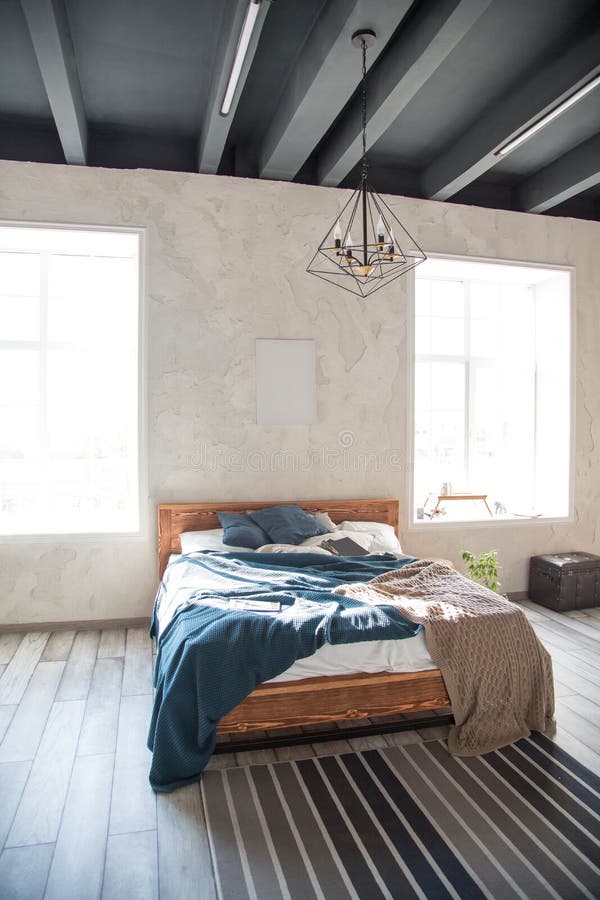 Bed with Wooden Frame in Loft Interior. Light Room Stock Photo - Image ...