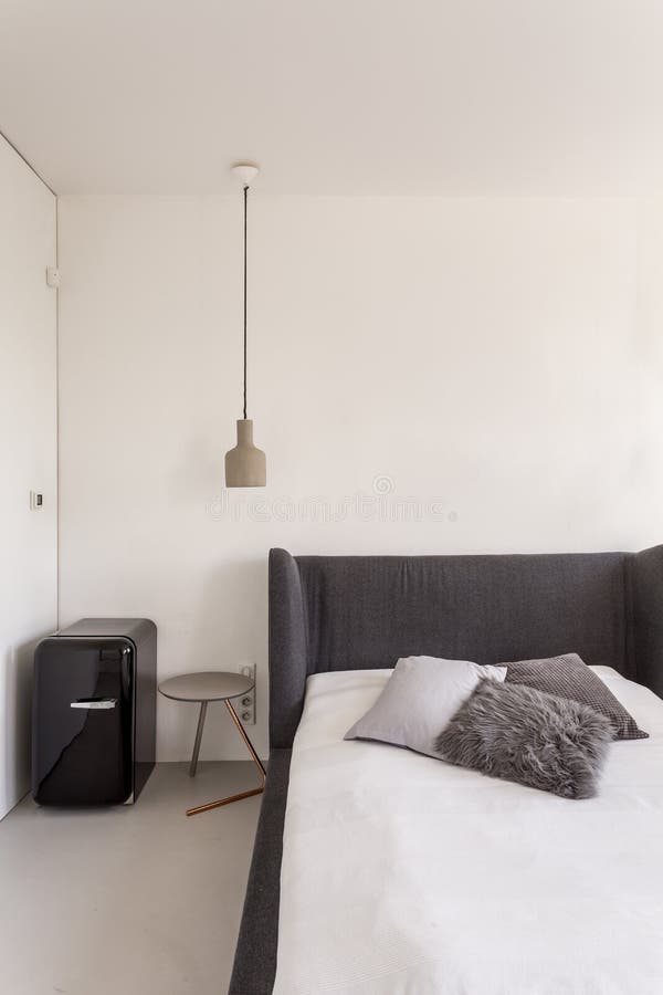Bedroom with Bed and Compact Fridge Stock Image - Image of white ...