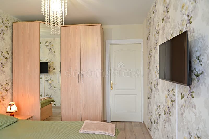 Bedroom Interior with Wardrobe and TV on the Wall Stock Image - Image ...
