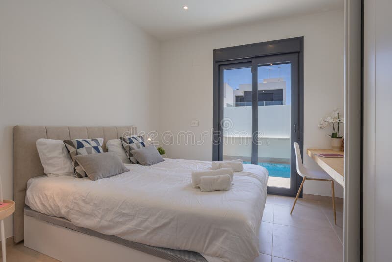 Bedroom with Pool View and Built-in Desk Stock Image - Image of towels ...