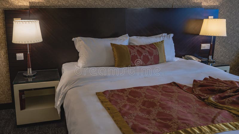 The Bedroom is Ready for Bed. a Double Bed with White Sheets and a Red ...