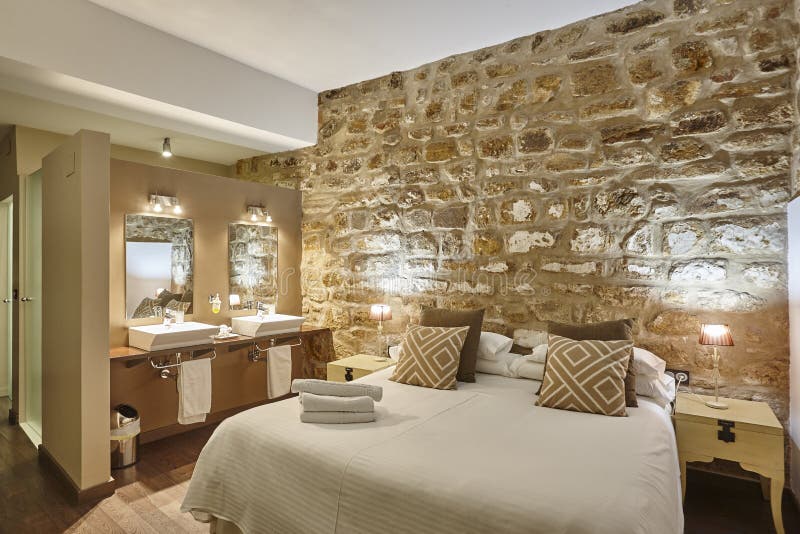 Bedroom with Stone Walls. Comfortable Modern Hotel Room Stock Image ...