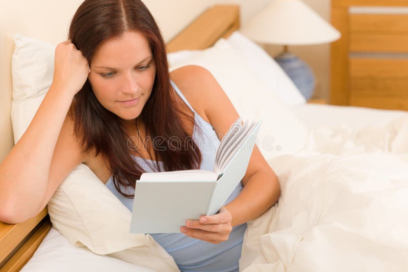 Woman reading in bed stock image. Image of girl, read - 65600227