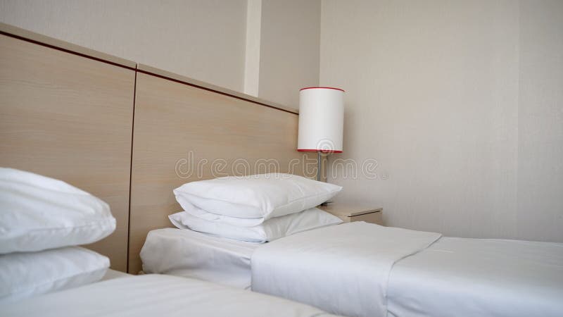 White Linens on a Bed in a Hotel Room. Bed with White Pillows in a ...