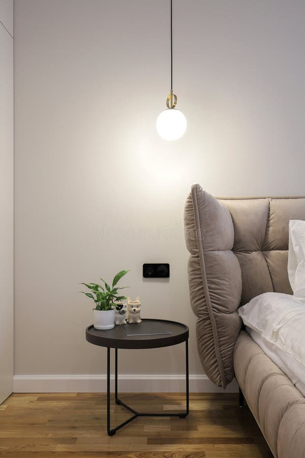 Bedside Table with Hanging Lamp Near the Bed in the Bedroom Stock ...