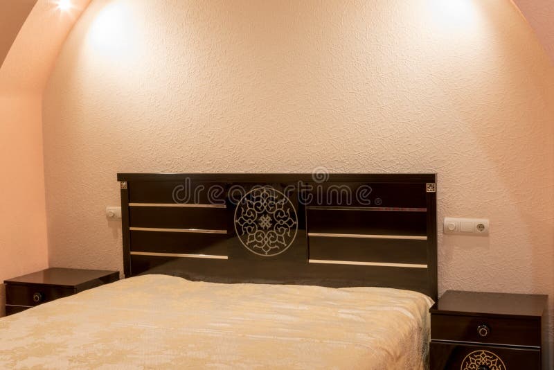 Bedside table near the bed stock image. Image of furniture - 65776151