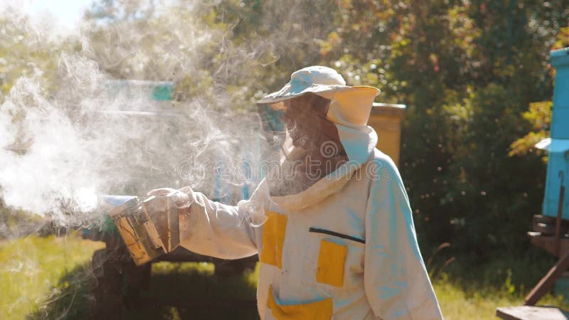 Bee-maker Beekeeper Man Working of a Smoke Pipe Beeper Smoker Device ...