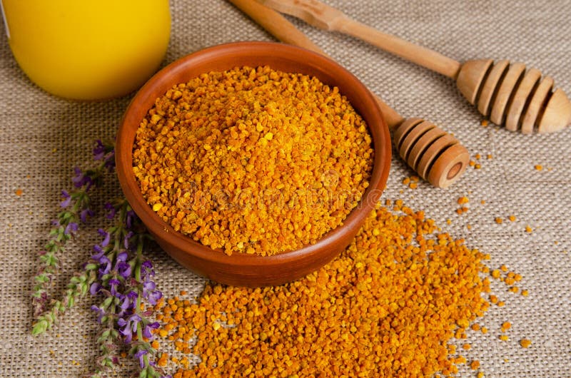Bee Pollen in Bowl with Spoon and Flower on Table Stock Photo - Image ...