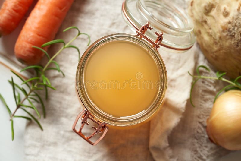 Beef Bone Broth in a Glass Jar with Fresh Vegetables, Top View Stock ...