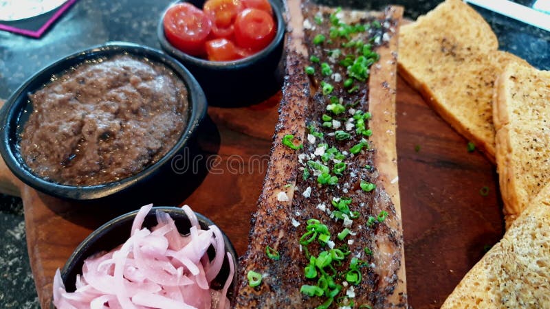 Beef Bone Marrow Grill with Pickle and Pate Sides Serve on Wood Plate ...
