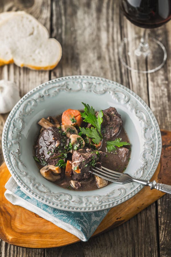 Beef Bourguignon in a Ceramic Dish on a Chopping Board Stock Image ...