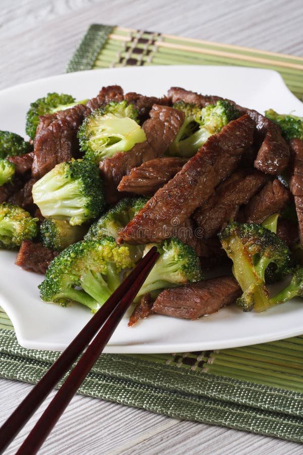 Beef with Broccoli on a Plate Closeup and Chopsticks. Vertical Stock ...