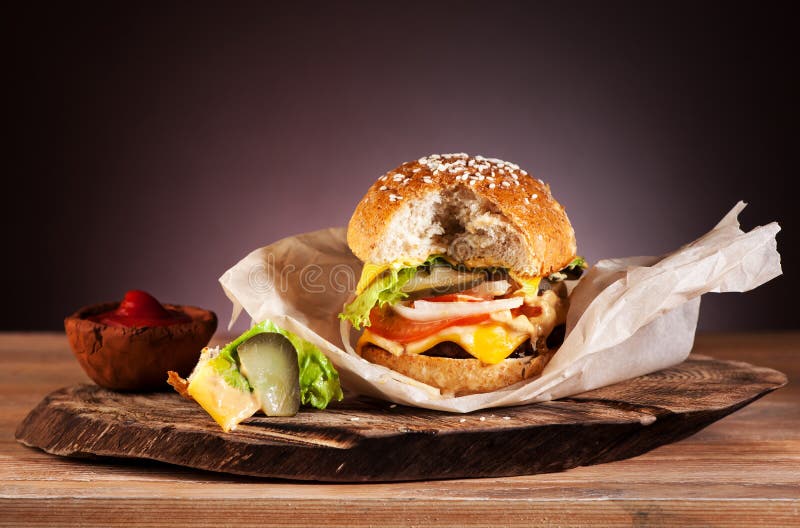Beef burger in brown paper stock image. Image of grilled - 82287093