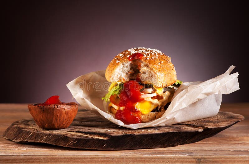 Beef burger in brown paper stock image. Image of grilled - 82288621