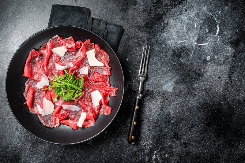 Beef Carpaccio Cold Appetizer with Parmesan and Arugula on a Plate ...