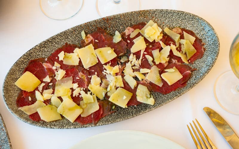 Beef Carpaccio with Slices of Cheese on Table Stock Image - Image of ...