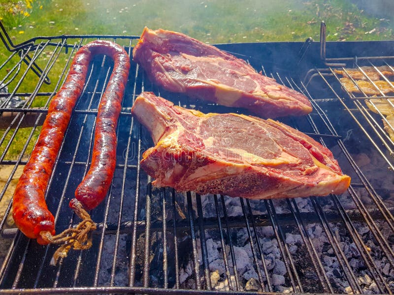 Beef and Cow Steak Grilled Next To Chorizo for Grilling Stock Photo ...