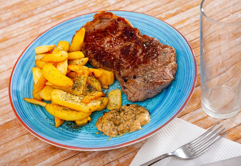Beef Entrecote with Potatoes Served at Plate Closeup Stock Image ...