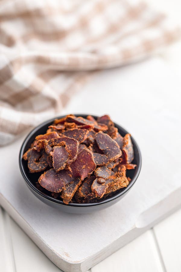 Beef Jerky. Dried Spiced Meat in Bowl on White Table Stock Image ...