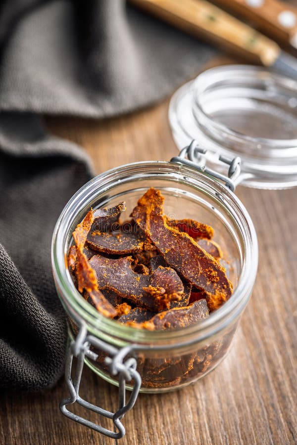 Beef Jerky. Dried Spiced Meat in Jar on Wooden Table Stock Image ...