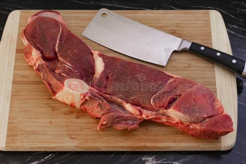 Beef Meat with Bone Lies on a Cutting Board, Next To a Knife Stock ...