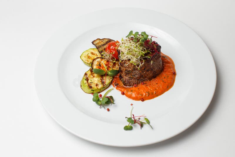 Beef Medallion in Carrot Sauce with Grilled Vegetables Stock Image ...