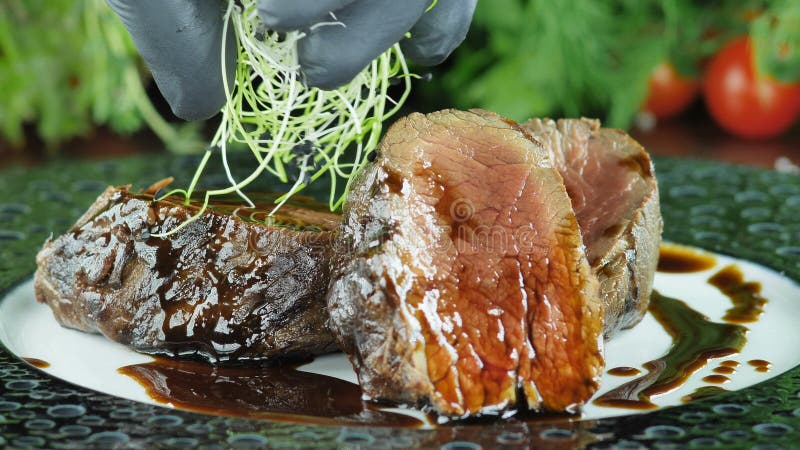 Beef on a Plate Pour the Sauce and Decorated with Greens in the ...