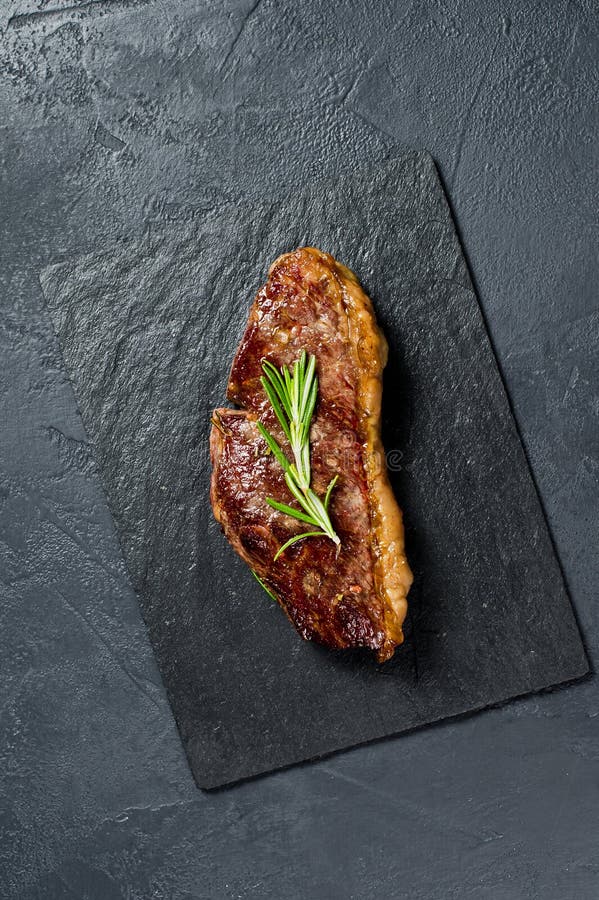 Beef Ramp Steak with Rosemary. Black Background, Top View. Stock Image ...