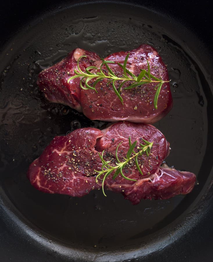 Beef steak on a dark pan stock image. Image of beef, freshness - 55064159