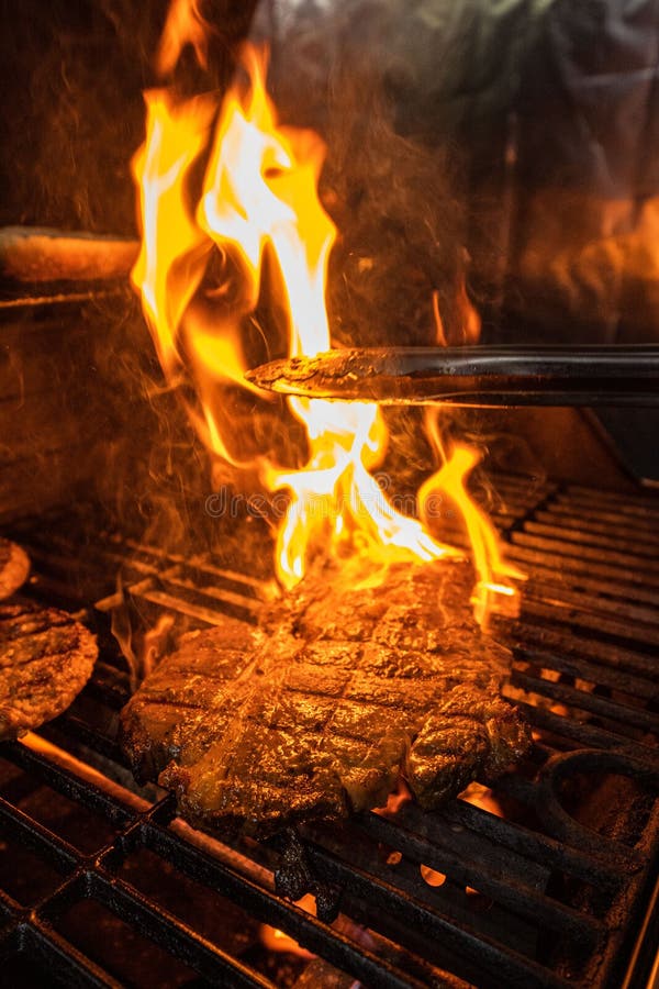 Beef Steak on the Grill with Flames Stock Photo - Image of cookout ...