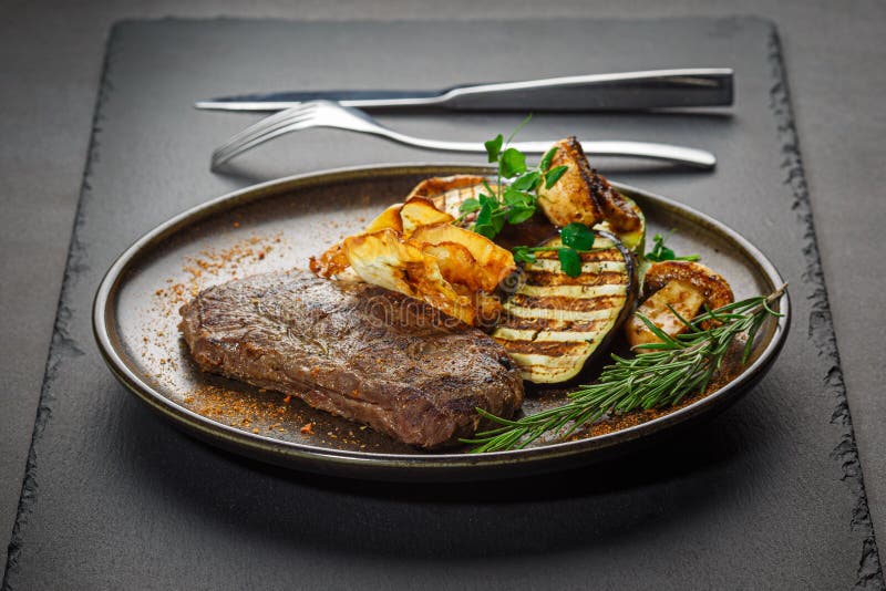 Beef Steak with Grilled Vegetables, Sprouts and Rosemary on a Dark ...