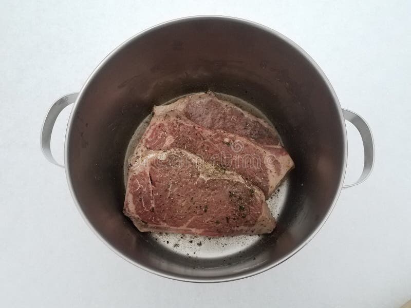 Beef Steak with Seasoning and Liquid in Metal Pot on Snow Stock Photo ...