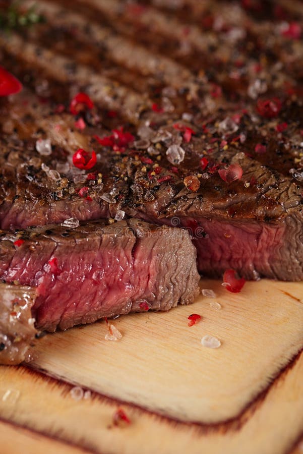 Beef Steak on a Wooden Board and Table Stock Image - Image of sirloin ...
