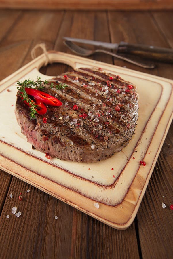Beef Steak on a Wooden Board and Table Stock Image - Image of protein ...