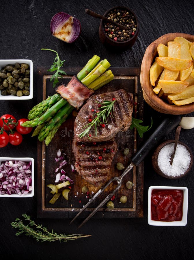 Beef steak on wooden table stock image. Image of board - 45618053
