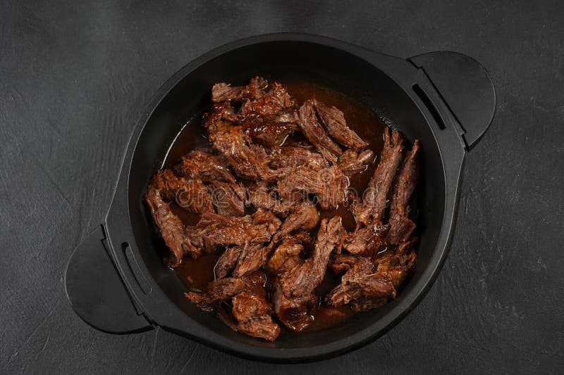 Beef Stew in a Cast Iron Skillet. Sliced Pieces of Braised Beef Stock ...