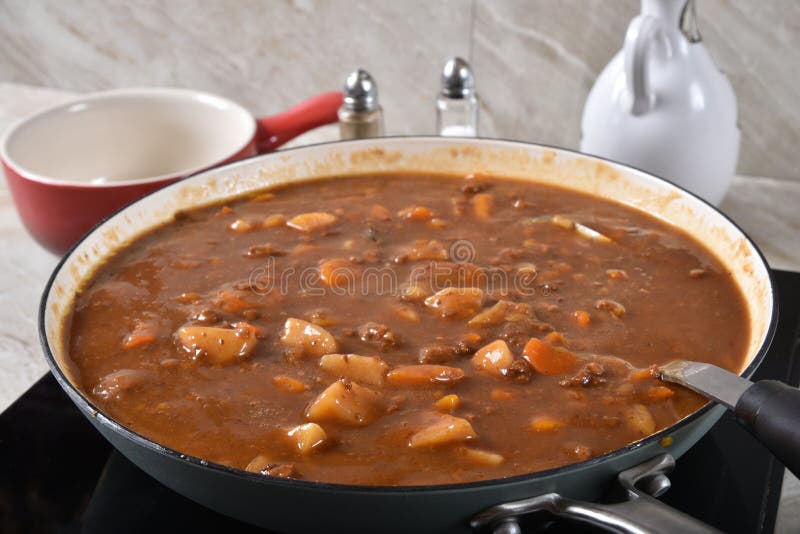 Beef Stew Simmering in a Pan Stock Photo - Image of iron, spoon: 139956996