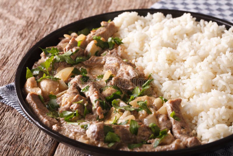 Beef Stroganoff Garnished with Rice Close-up on a Plate. Horizon Stock ...
