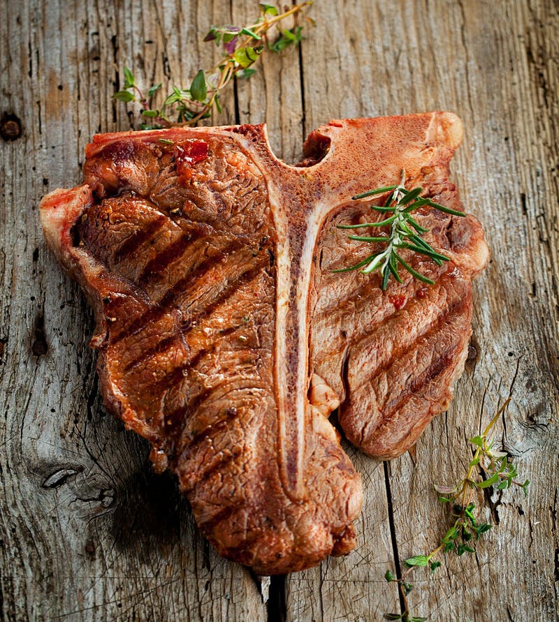 Beef T-bone Steaks on Dark Old Wooden Board Stock Image - Image of ...