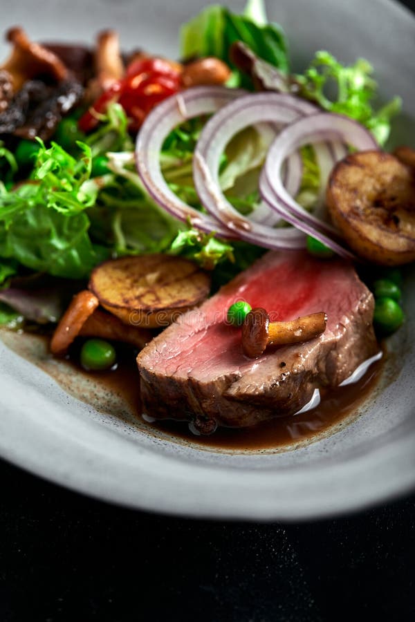 Beef Tagliata with Vegetables. Close-up, Low Key, Gray Background ...