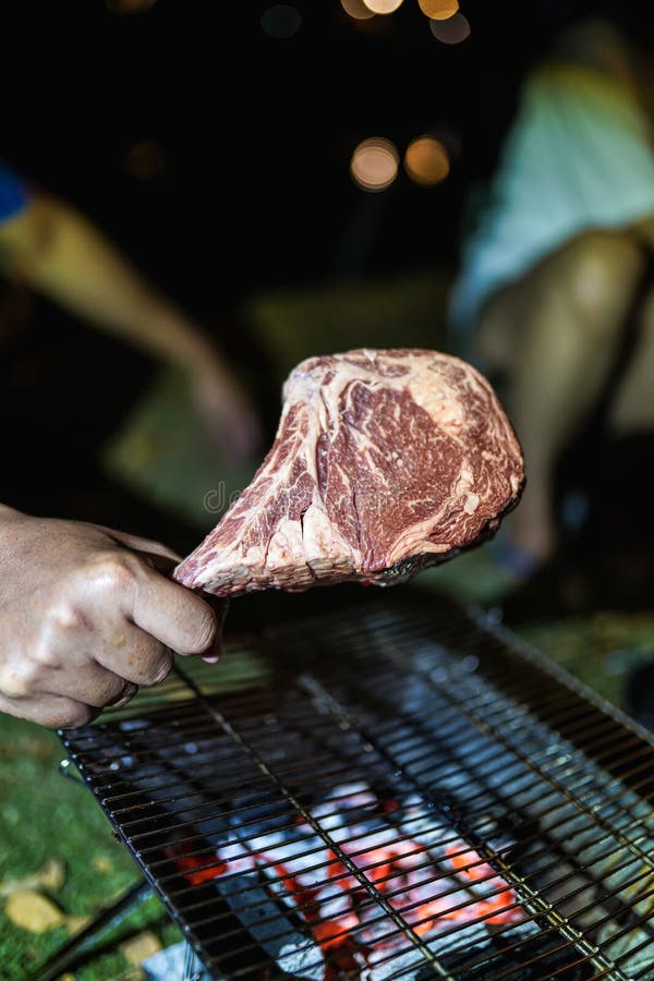 Beef Tomahawk Steak before the Grill with Smoke and Flames Stock Photo ...
