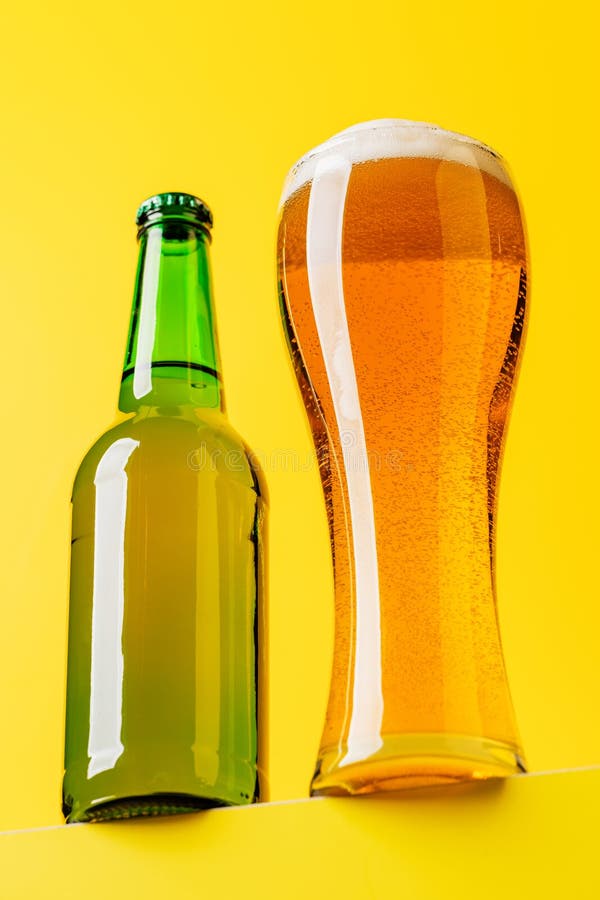 Beer Bliss: Refreshing Brew Against a Vibrant Yellow Backdrop Stock ...