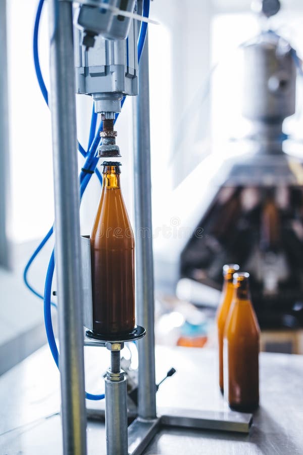 Beer Bottle Capping Machine in Brewery. Stock Photo - Image of ...