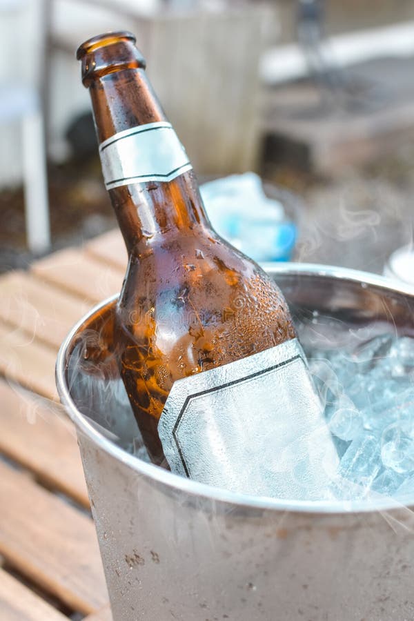 Beer Bottle in Ice Bucket stock image. Image of closeup - 129982557