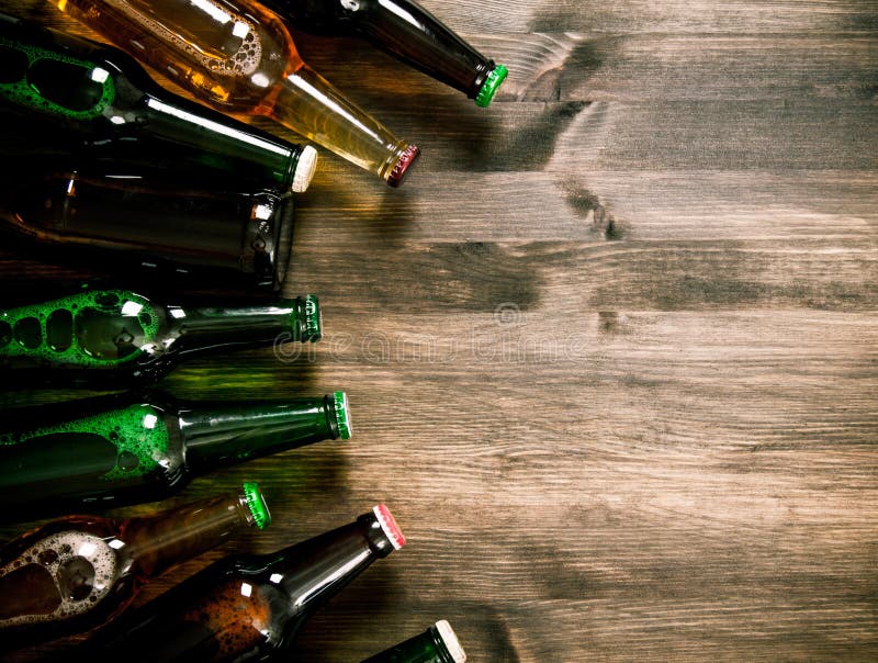 Beer Bottles on Wooden Table . Stock Image - Image of alcohol, drink ...